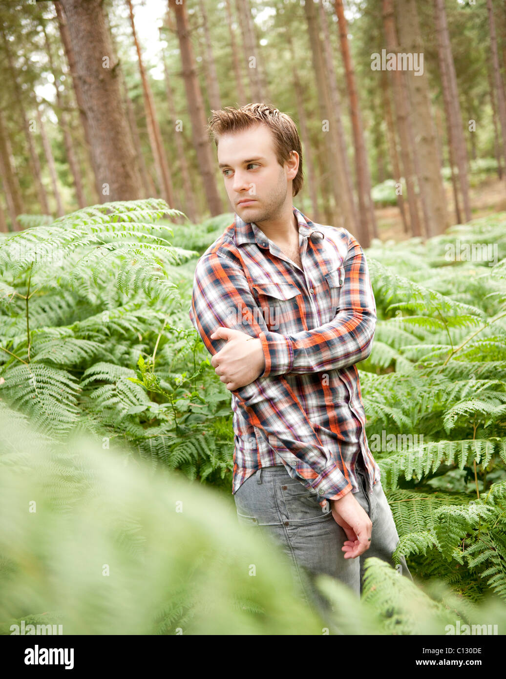 portrait of young man in forest Stock Photo - Alamy