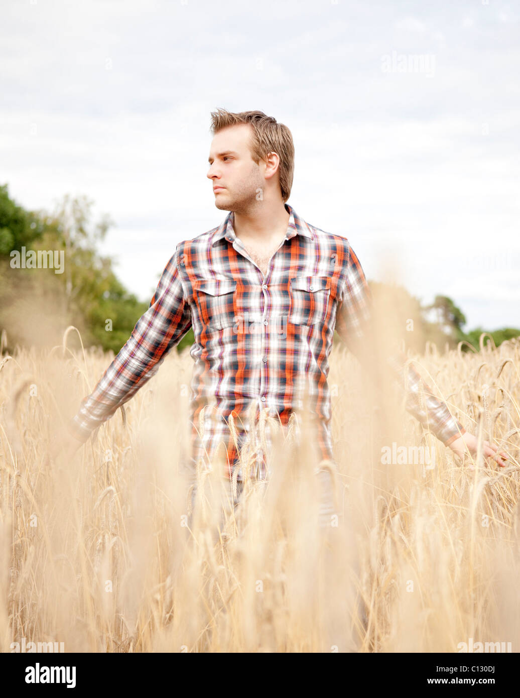 portrait of young man standing in field Stock Photo - Alamy