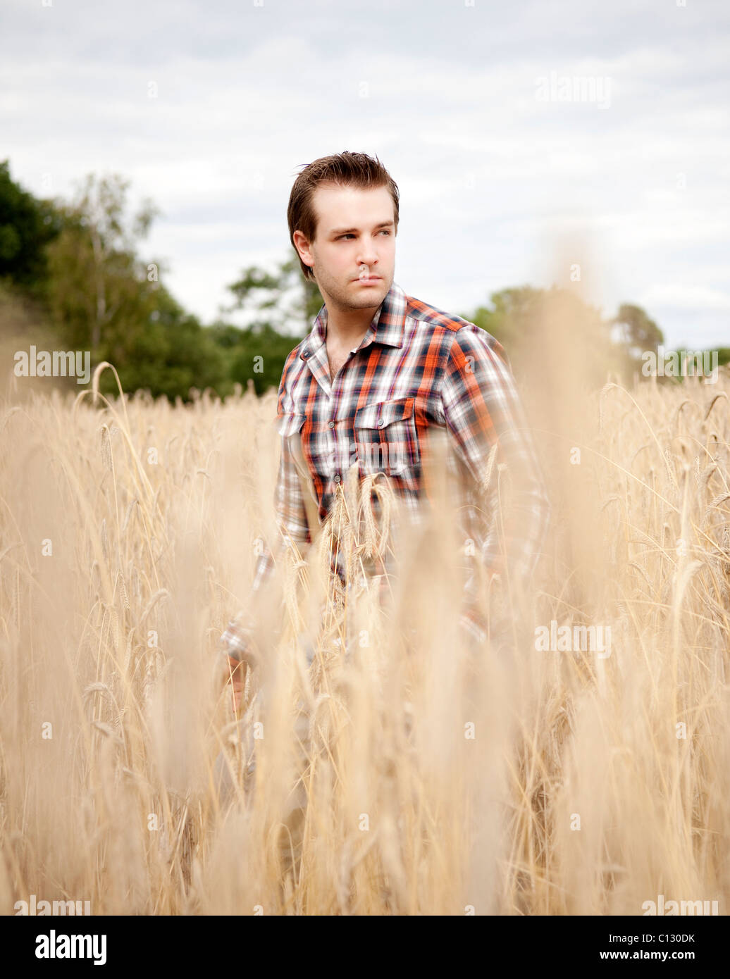 portrait of young man standing in field Stock Photo - Alamy