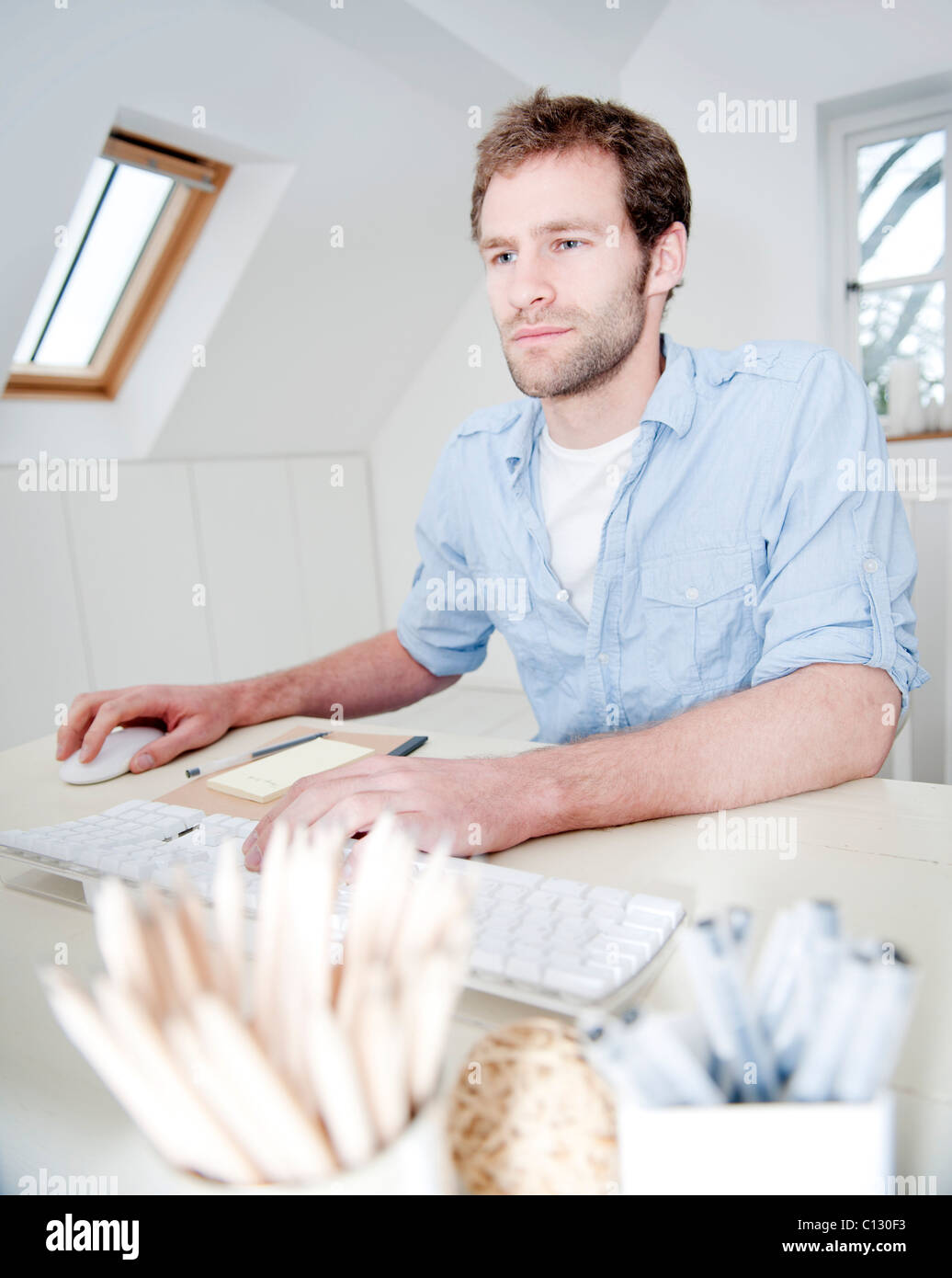 portrait of young man working with computer at home Stock Photo - Alamy
