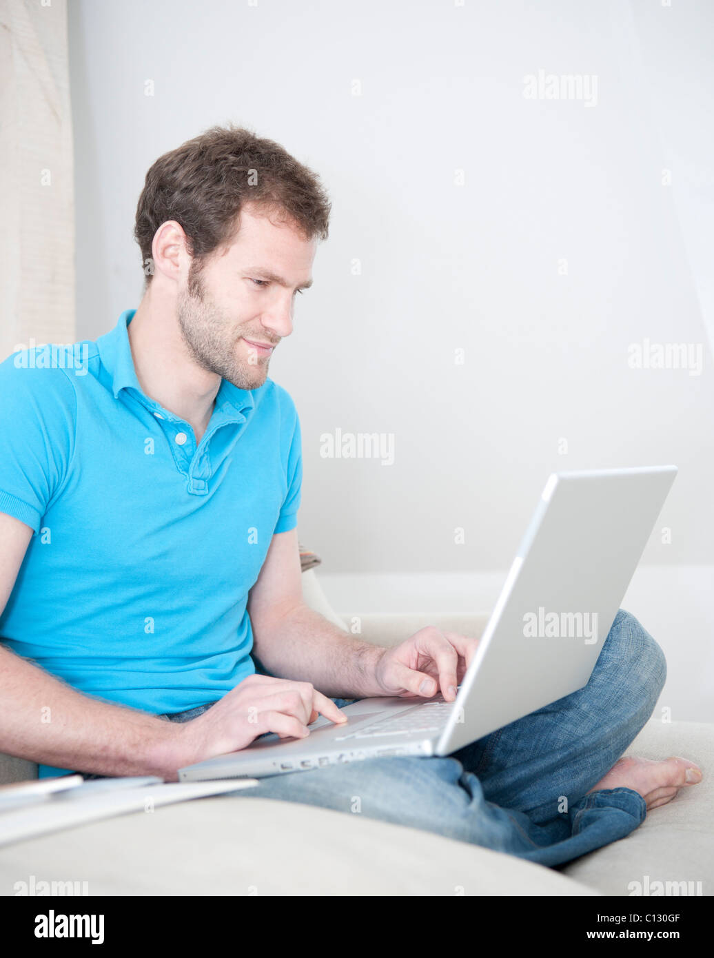 young man at home working with laptop computer Stock Photo - Alamy
