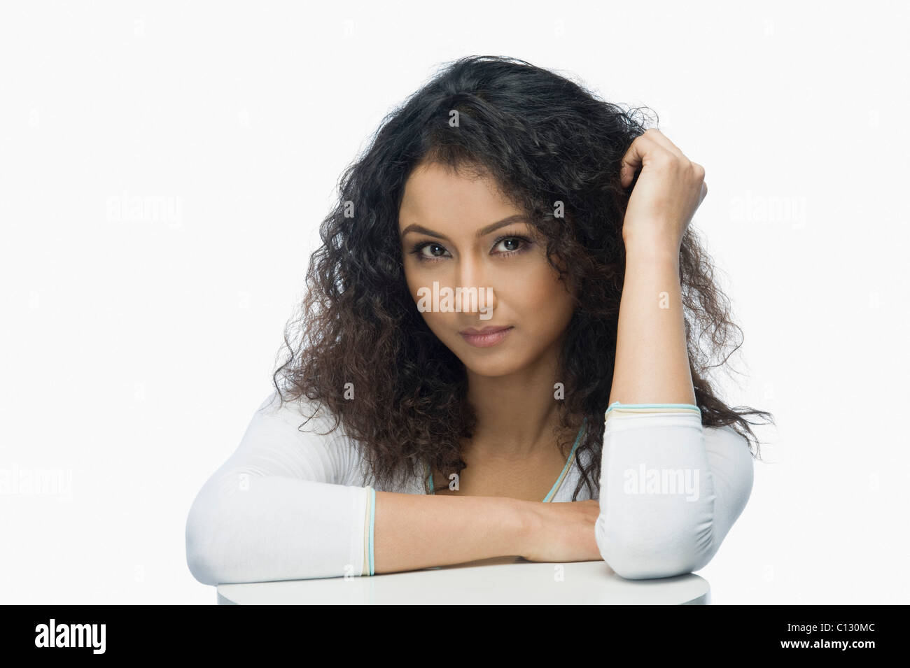 Portrait of a woman leaning on a stool Stock Photo - Alamy