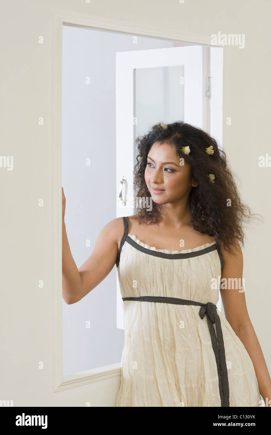 Close-up of a woman looking through a window Stock Photo - Alamy