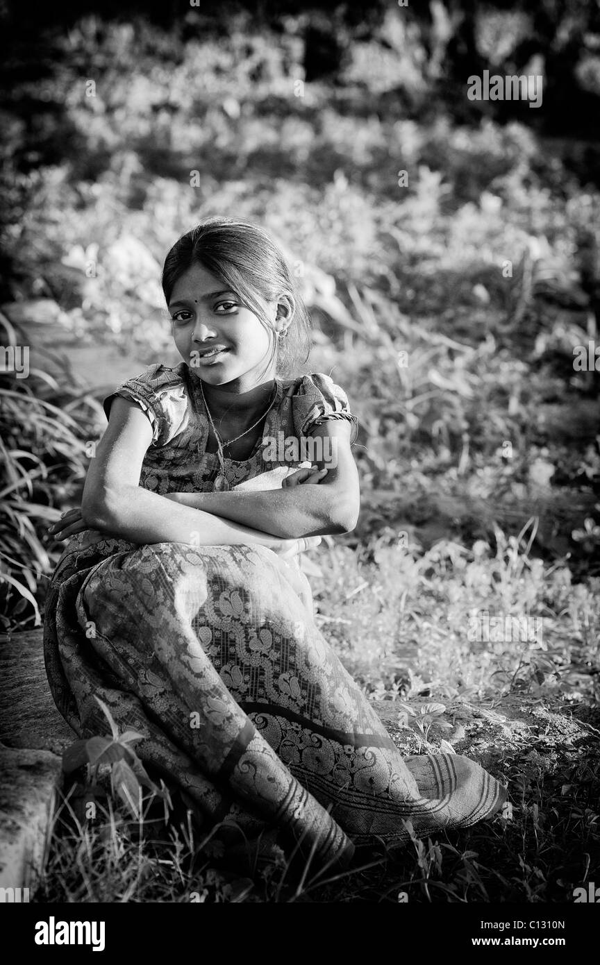 Smiling happy Indian village girl sitting in a field, Andhra Pradesh ...