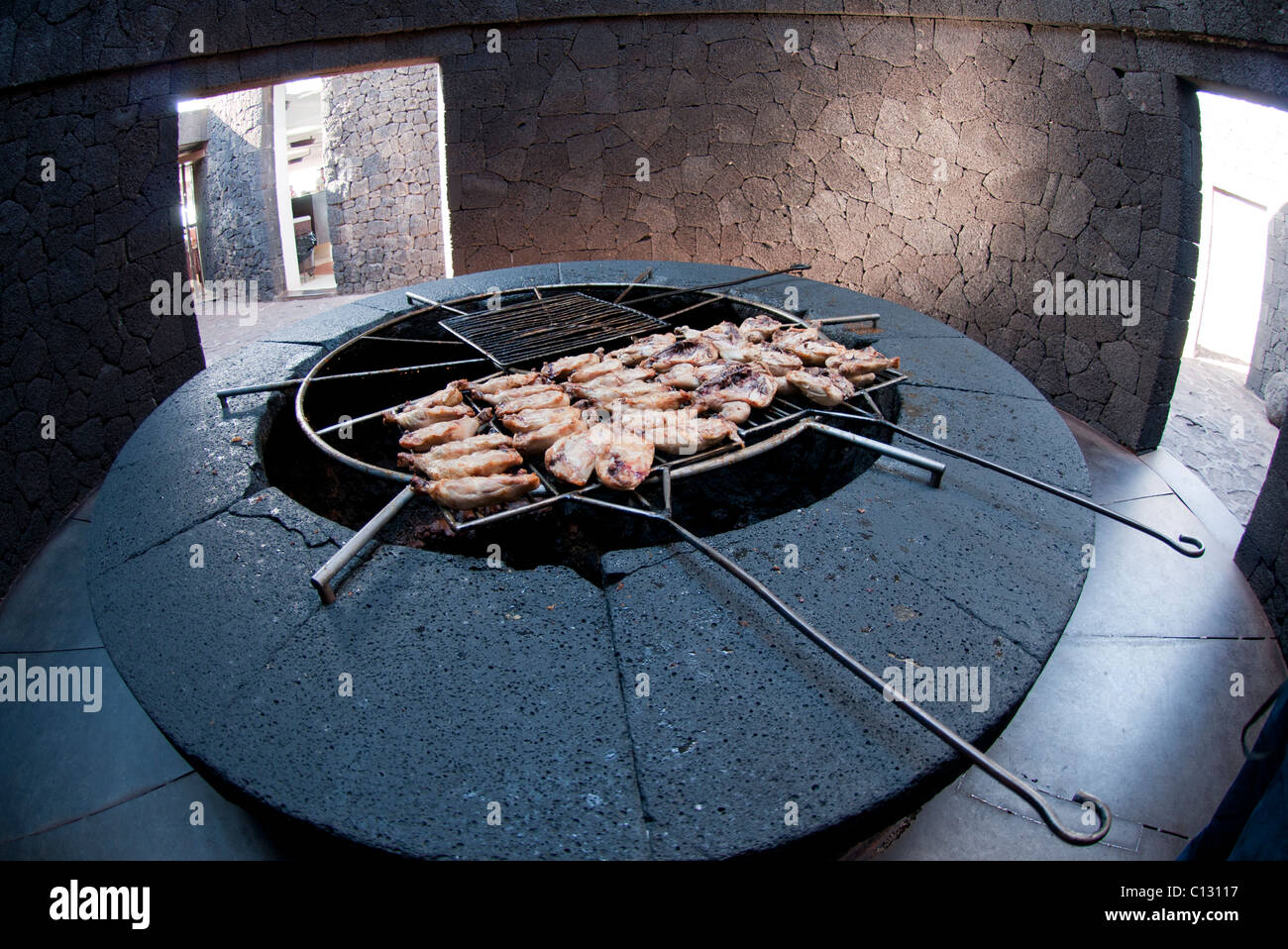 chicken being cooked on grill over volcano Lanzarote Stock Photo - Alamy