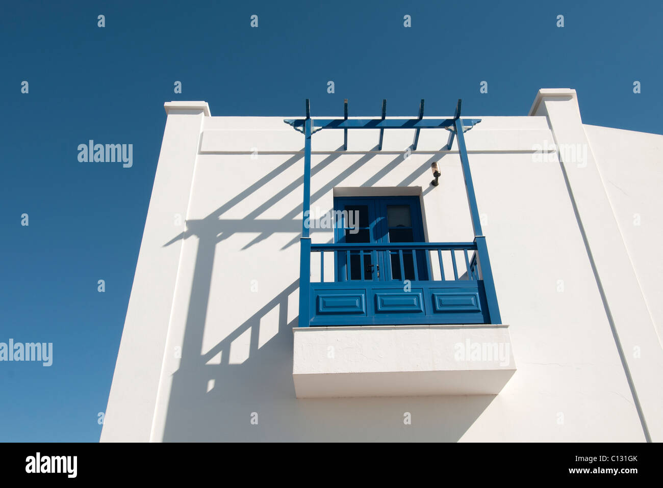 white building with blue window Stock Photo - Alamy