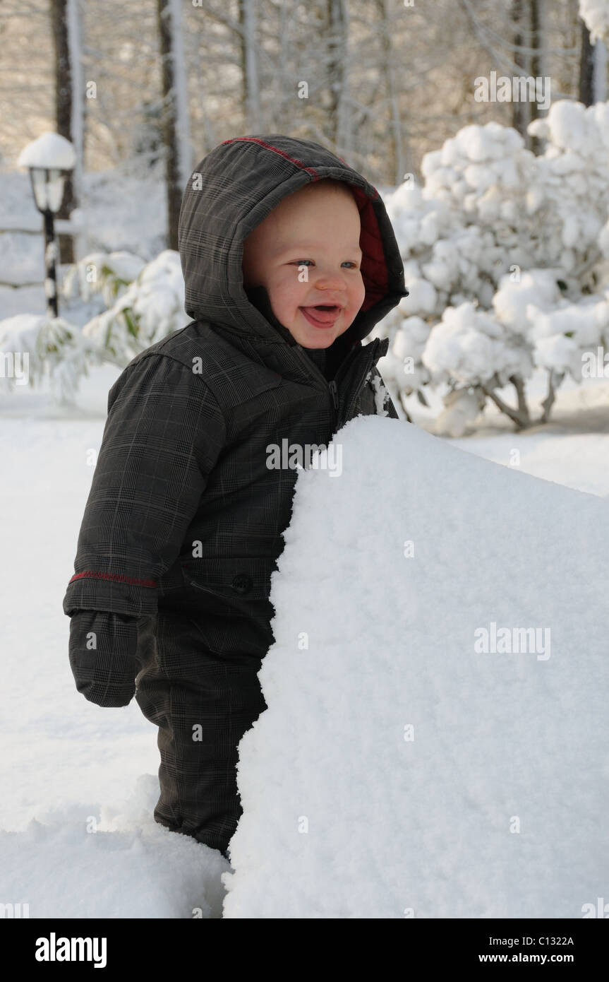 Baby having fun in the snow Stock Photo - Alamy