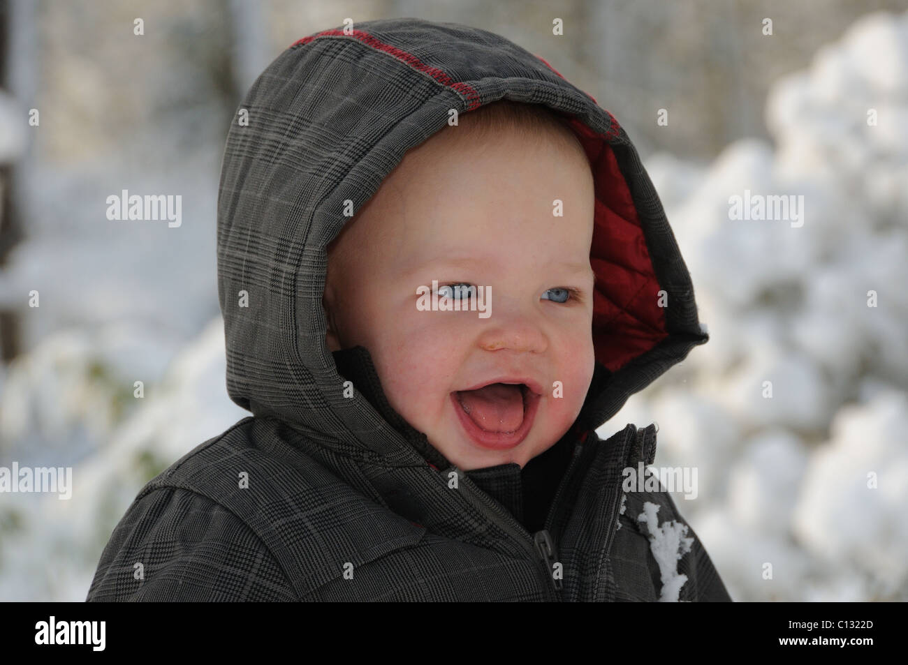 Baby having fun in the snow Stock Photo - Alamy