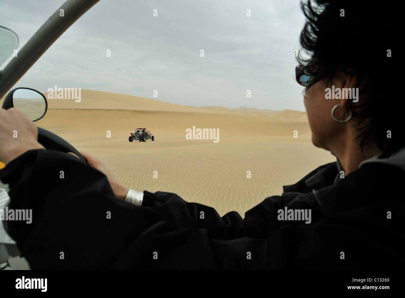 Scene of woman driving 4X4 dune buggy in desert on ATV tour Swakopmund ...