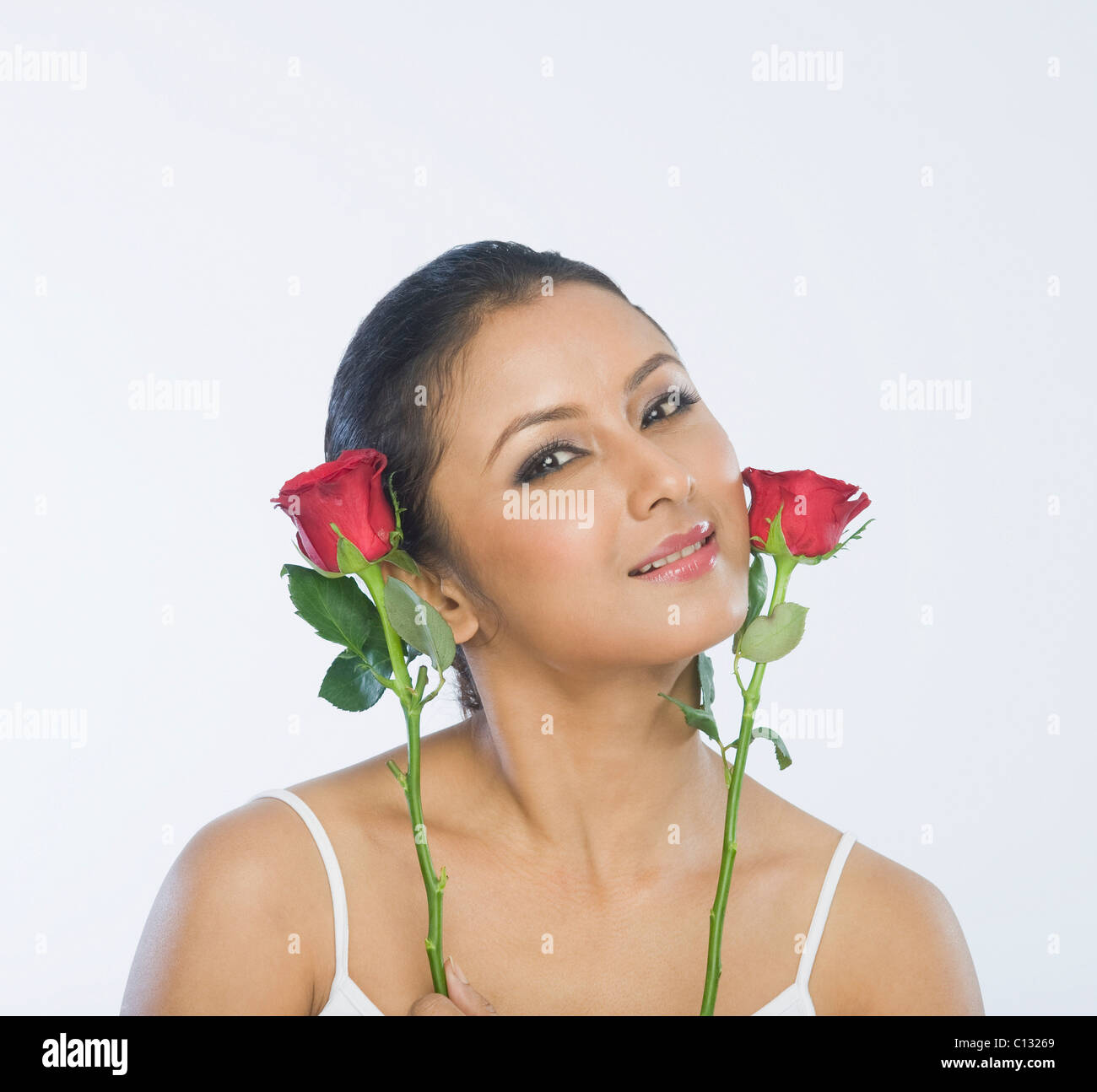 Portrait of a woman with red roses Stock Photo - Alamy