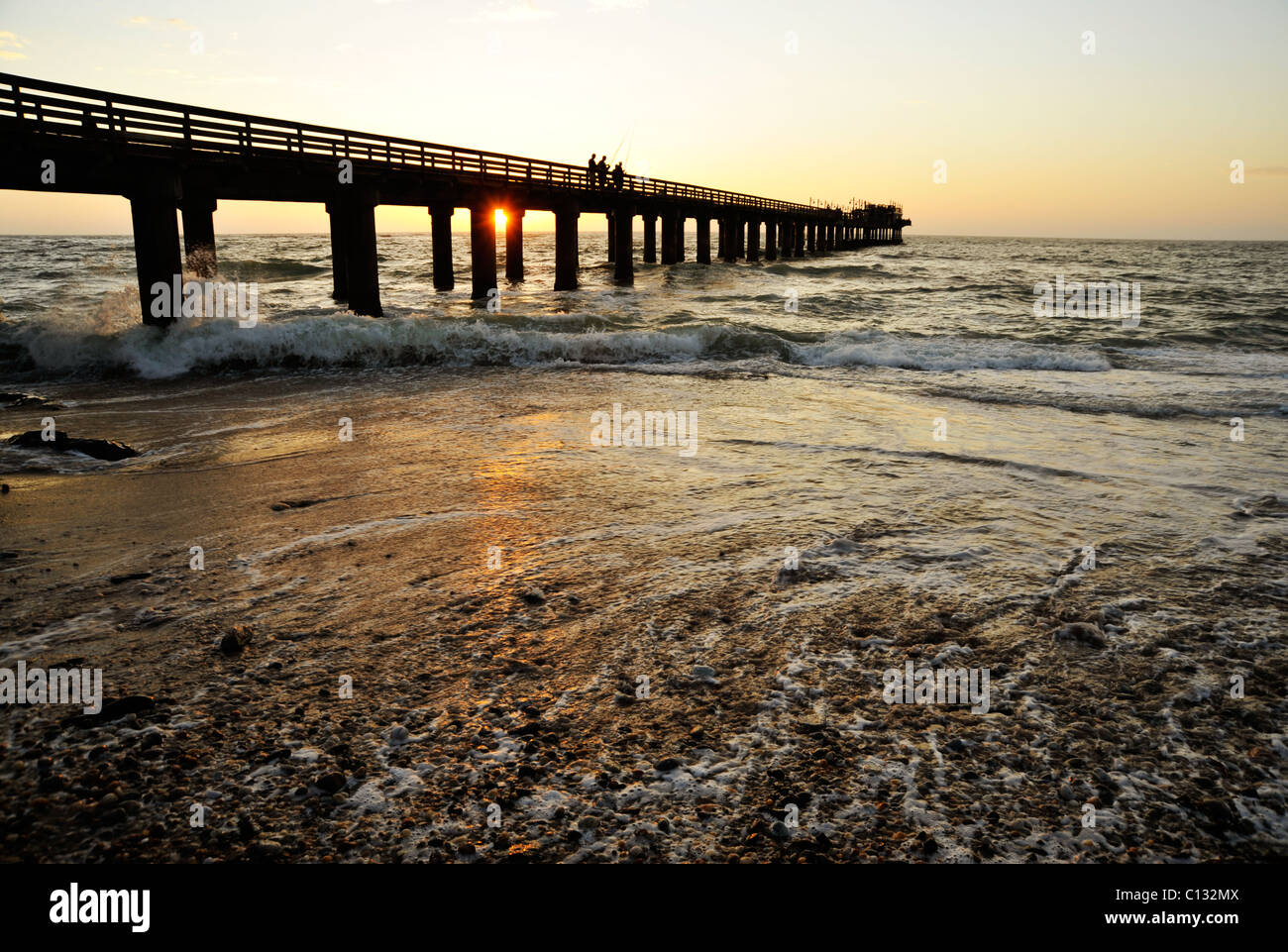 Scene of sunlight reflecting on water at sunset Swakopmund pier Namibia ...