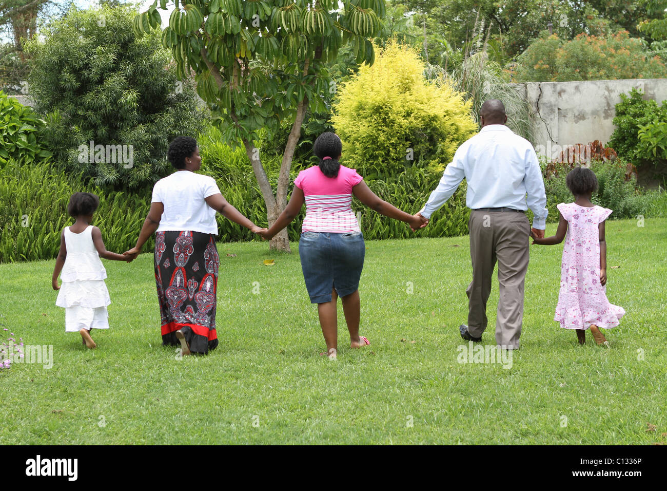Family holding hands and walking away, Harare, Zimbabwe Stock Photo - Alamy