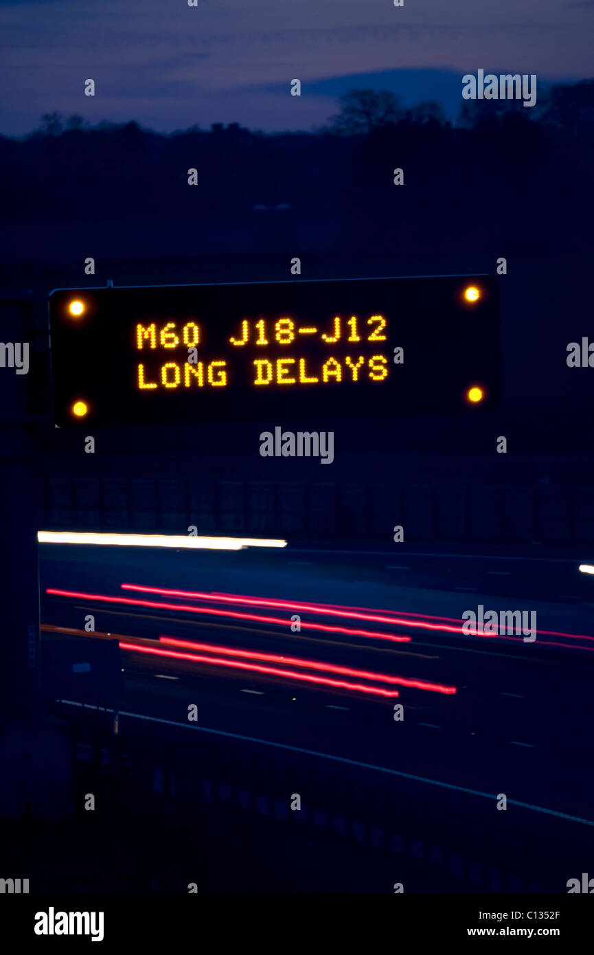 headlight trails of traffic on the A1/M motorway passing gantry warning ...