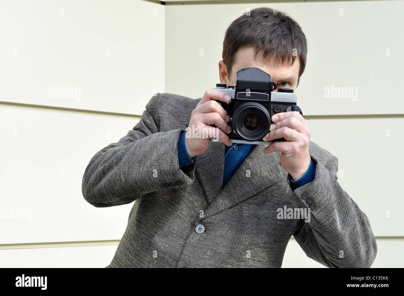 Photographer making a snapshot with retro camera Stock Photo - Alamy