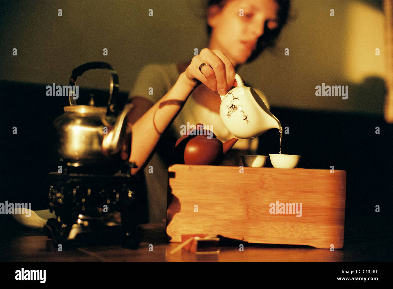 Young woman making a cup of tea Stock Photo - Alamy
