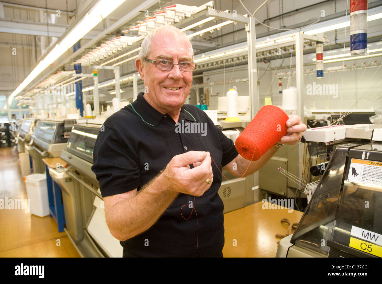 Preparing a Bobbin for weaving machine Stock Photo - Alamy
