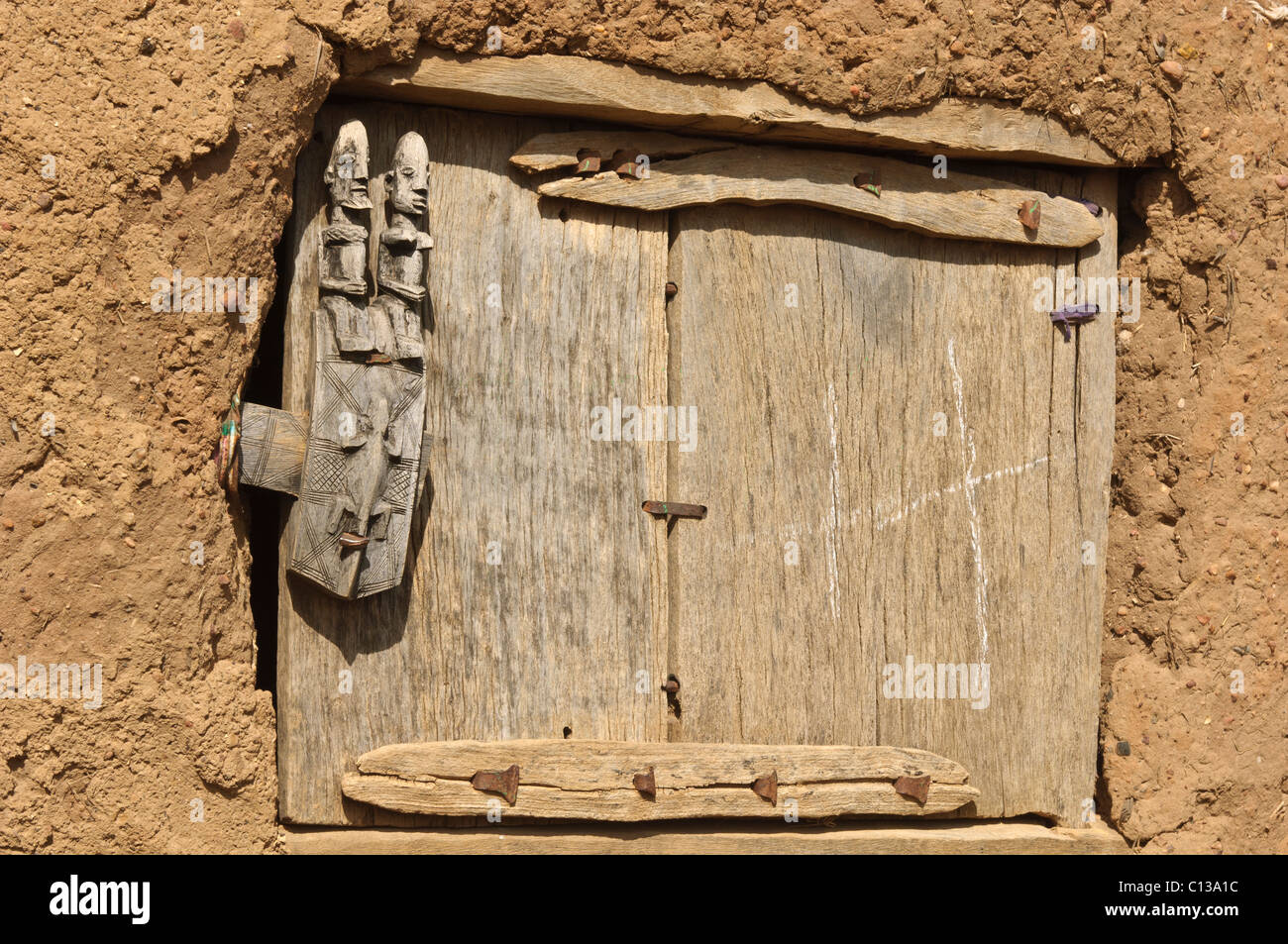 Granary door with carved Dogon wooden door lock. Begnemato village on ...