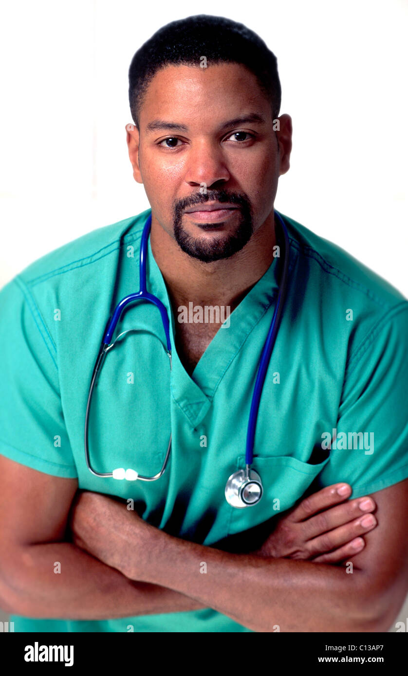 Portrait of serious looking doctor wearing scrubs Stock Photo - Alamy
