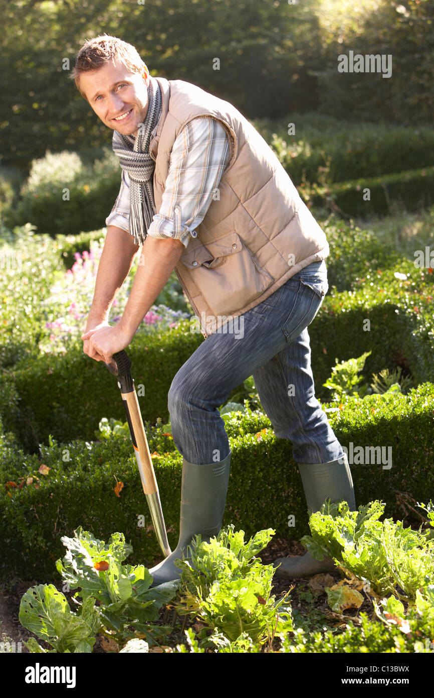 Young man working in garden Stock Photo - Alamy