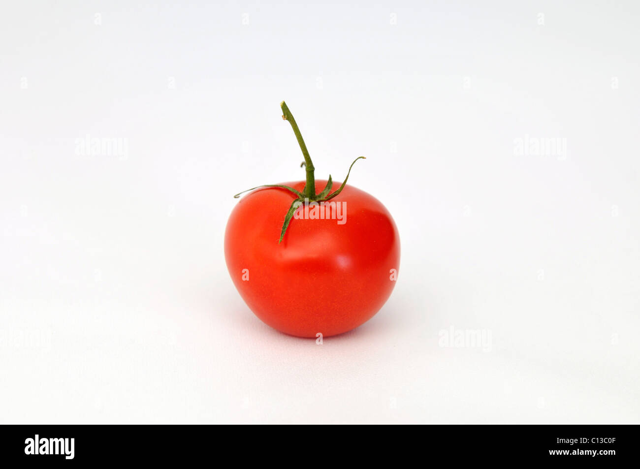 One tomato with white background Stock Photo - Alamy