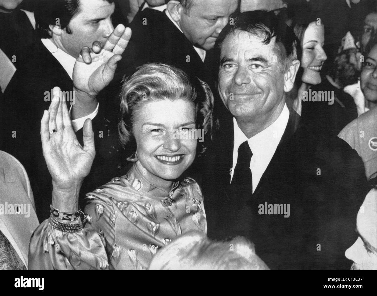 First Lady Betty Ford and actor Glenn Ford wave to the crowd at a ...