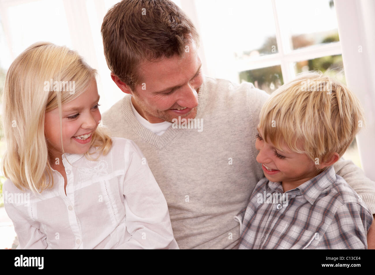 Man and children pose in studio Stock Photo - Alamy