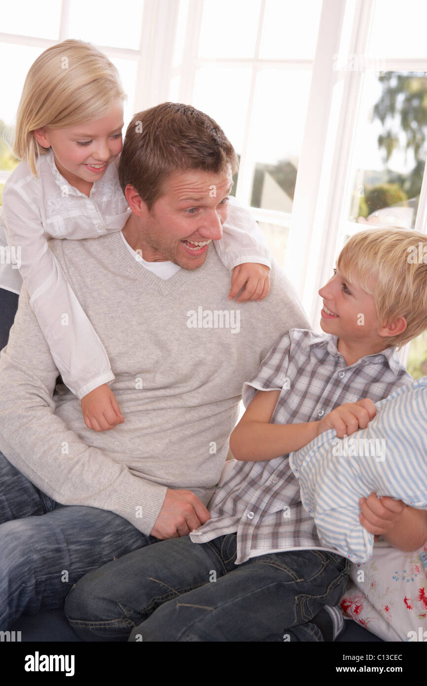 Man and children play together Stock Photo - Alamy