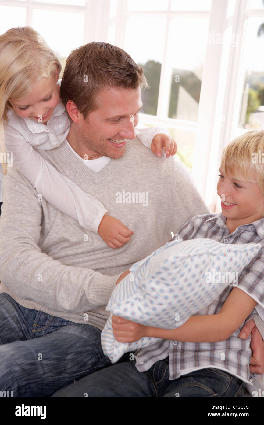 Man and children play together Stock Photo - Alamy