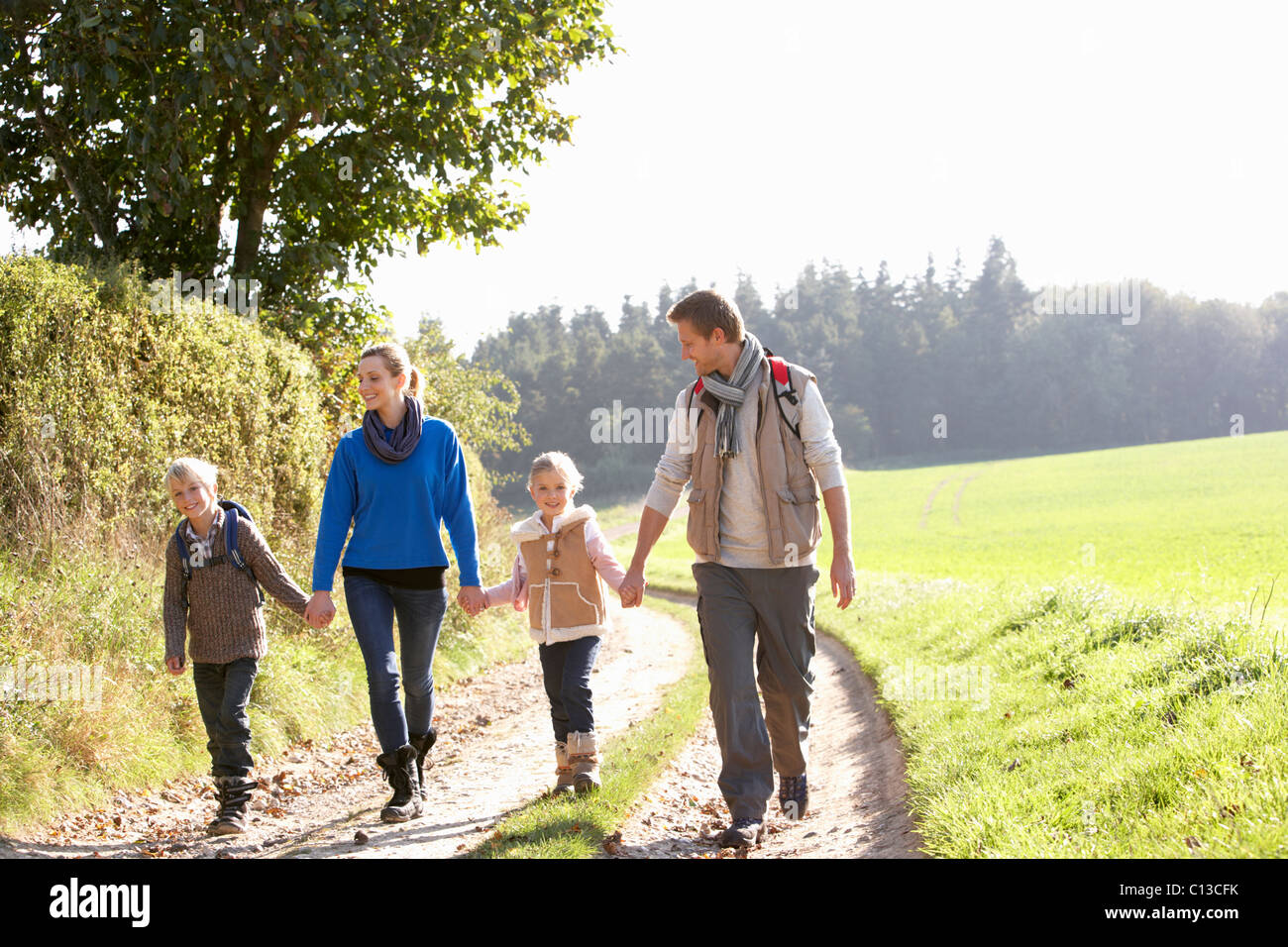 Young family walking in park Stock Photo - Alamy