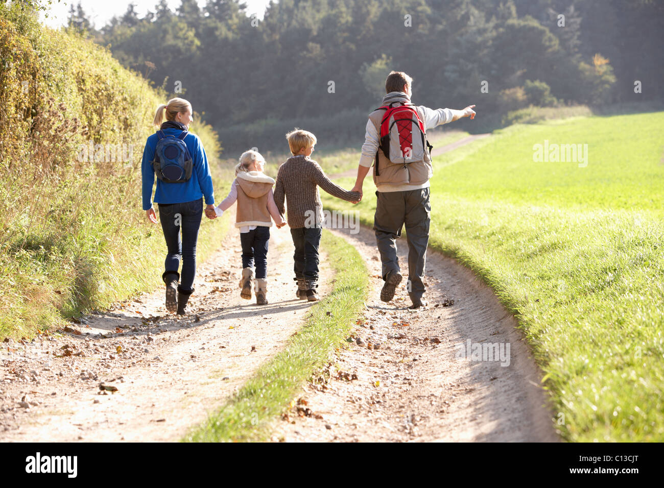 Young family walking in park Stock Photo - Alamy