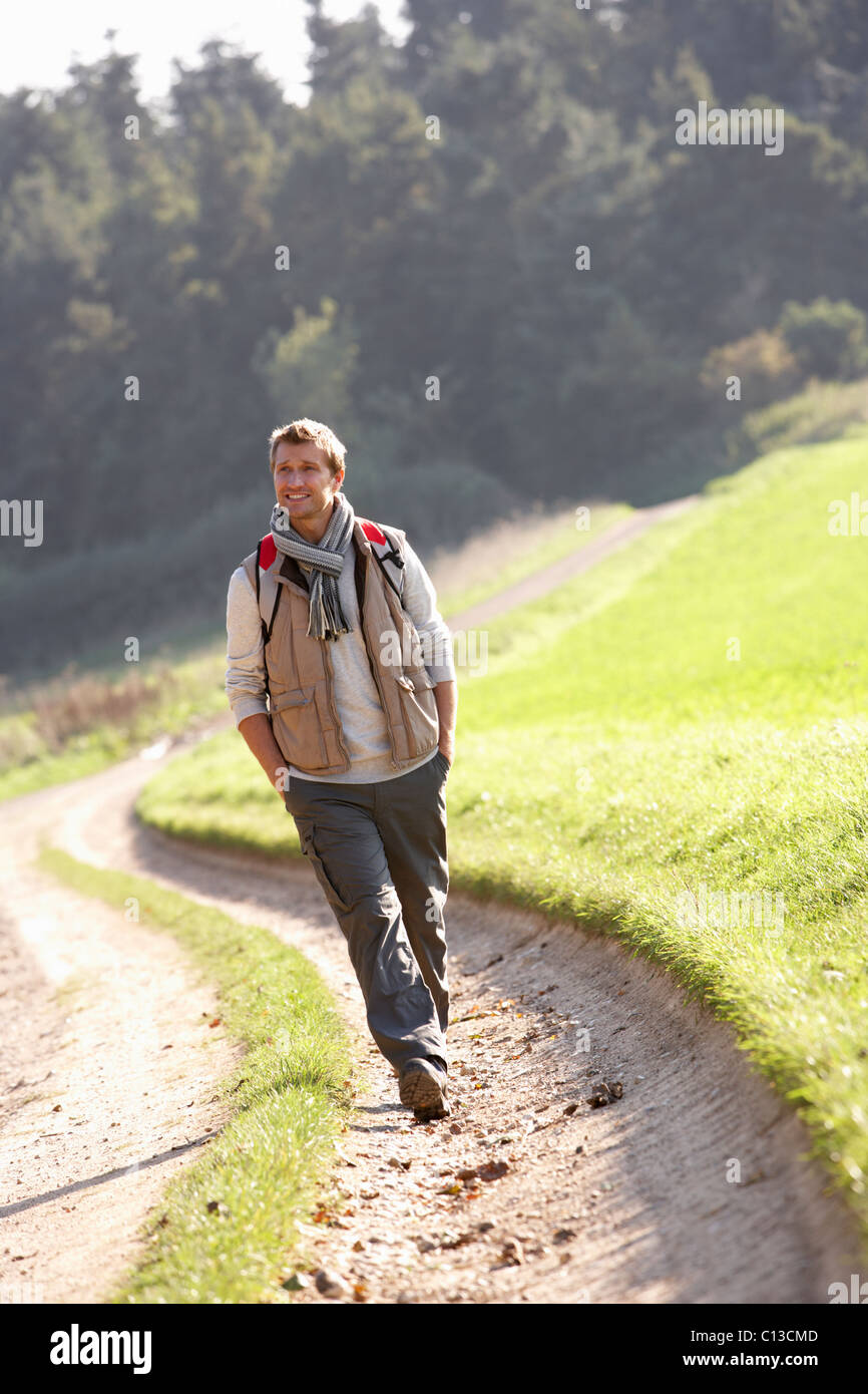 Young man walks in park Stock Photo - Alamy