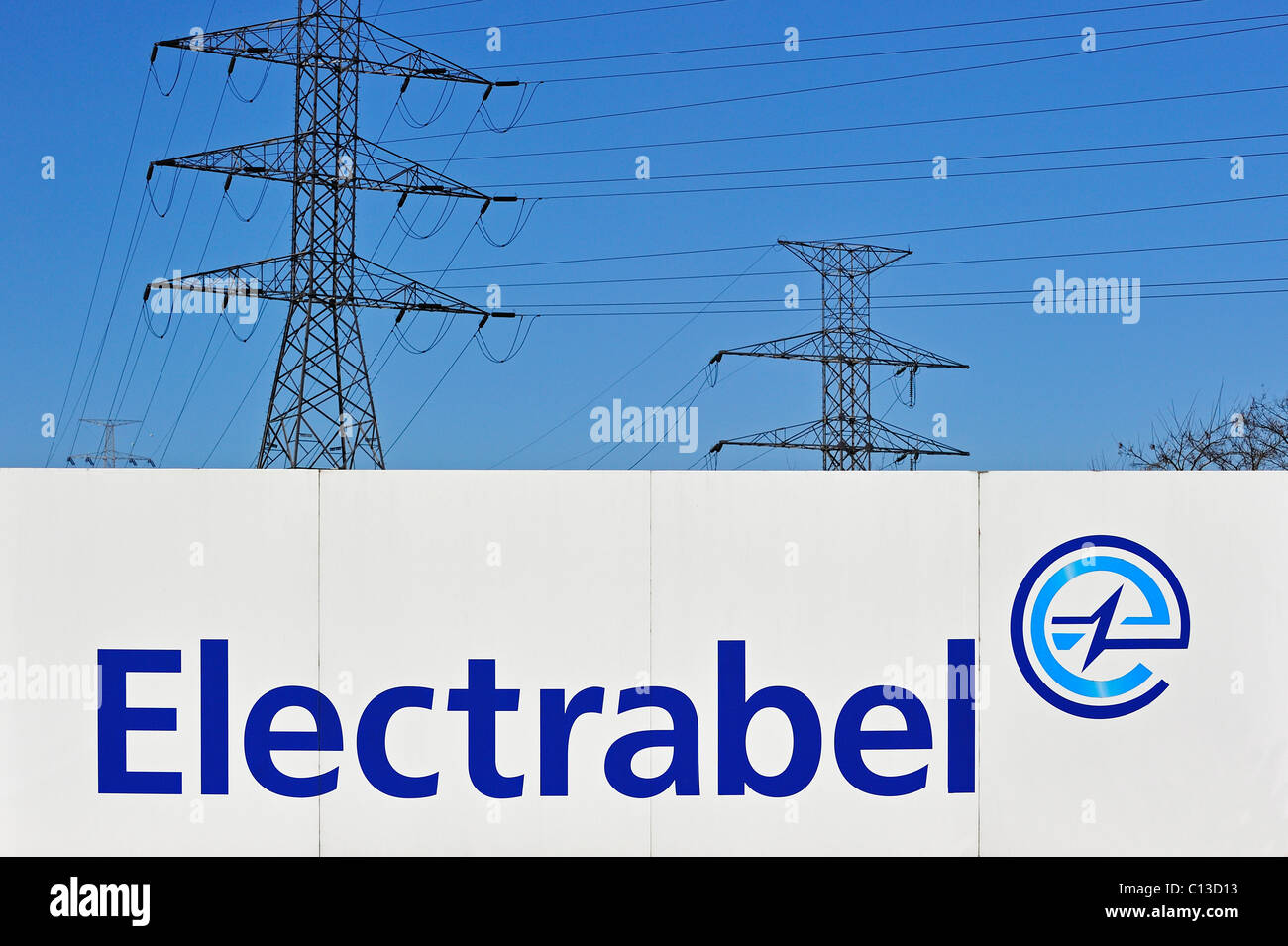 Electricity high-tension pylons and sign with logo of energy ...
