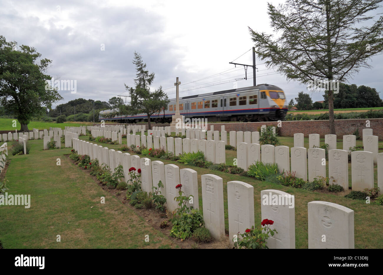 A train passes line of headstones in the CWGC Larch Wood Railway ...