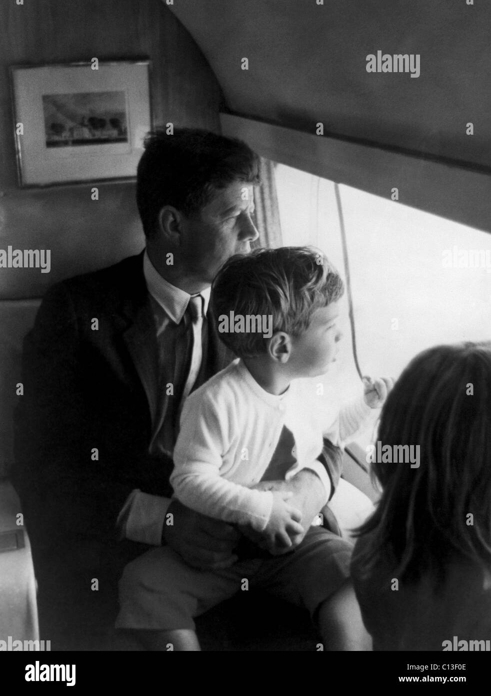 John F. Kennedy, John F. Kennedy Jr. looking out of airplane window ...