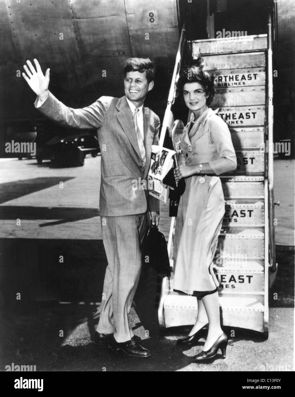 JOHN F. KENNEDY and wife JACQUELINE KENNEDY wave to photographers, 1955 ...
