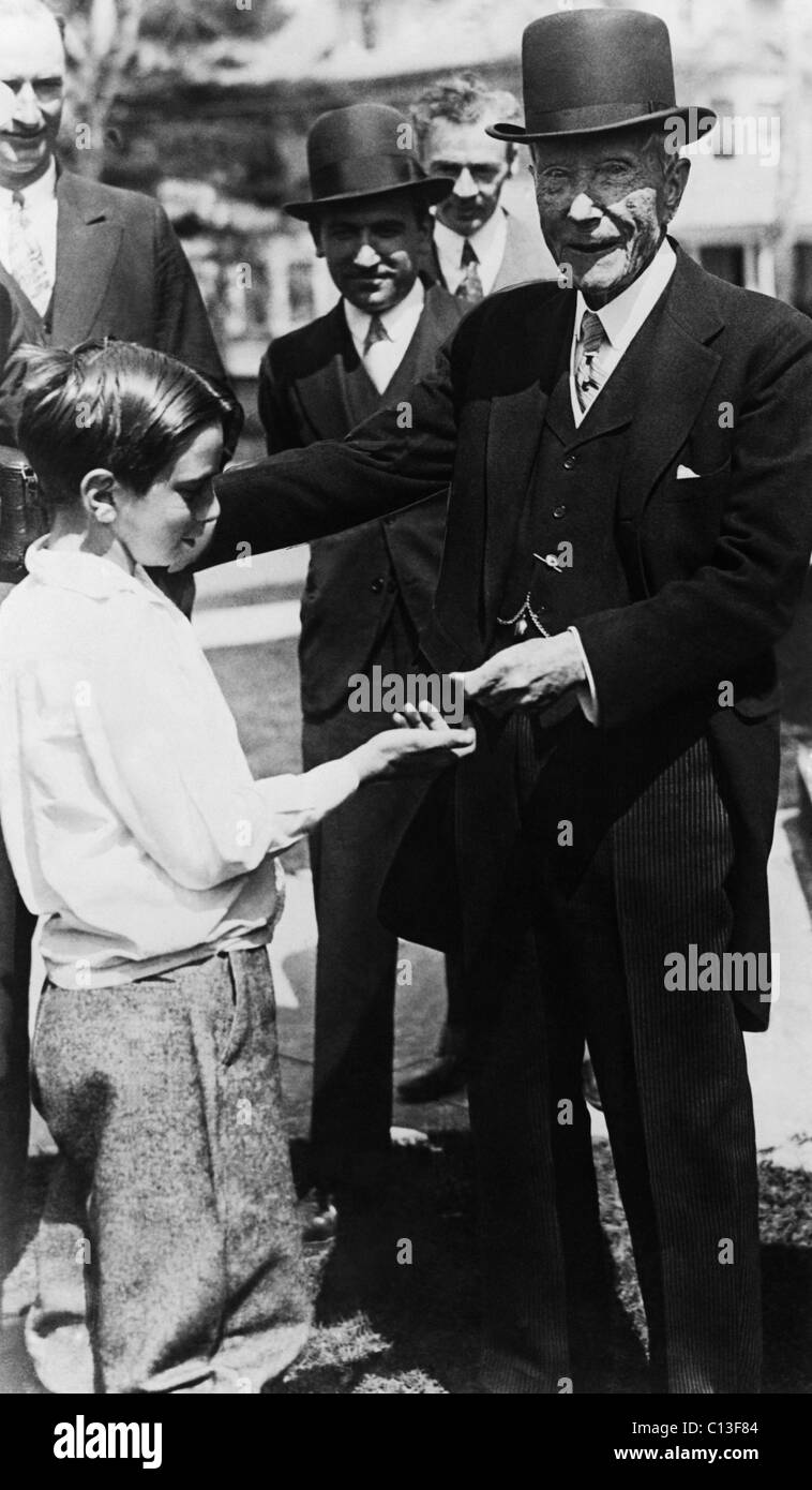 Rockefeller Family. William Gebele receiving a dime from industrialist ...