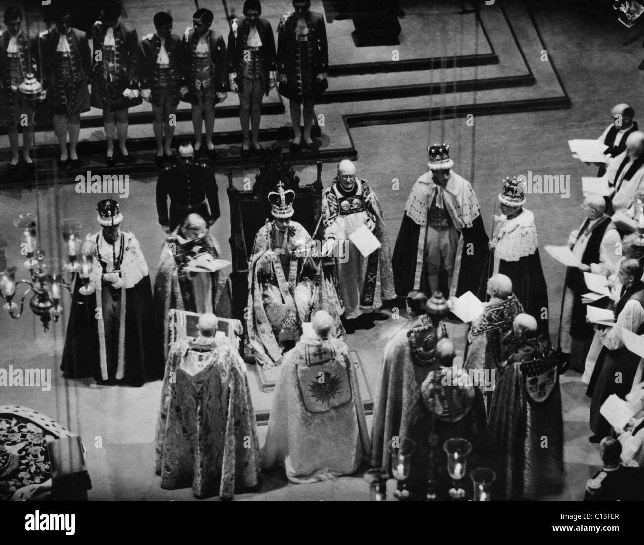 British Royalty. Center, on throne: King George VI, receving blessing ...