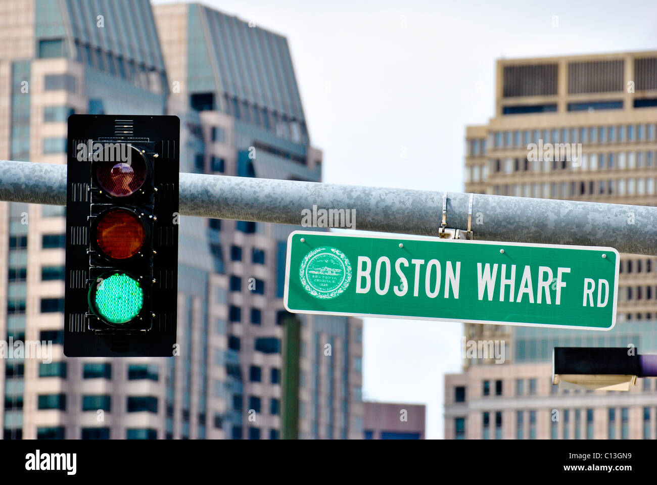 Street sign and traffic lights over the road in front of Boston ...