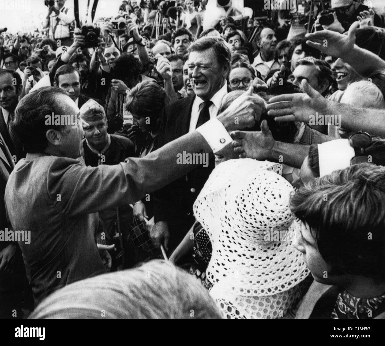 Nixon Presidency. US President Richard Nixon is greeted by John Wayne ...