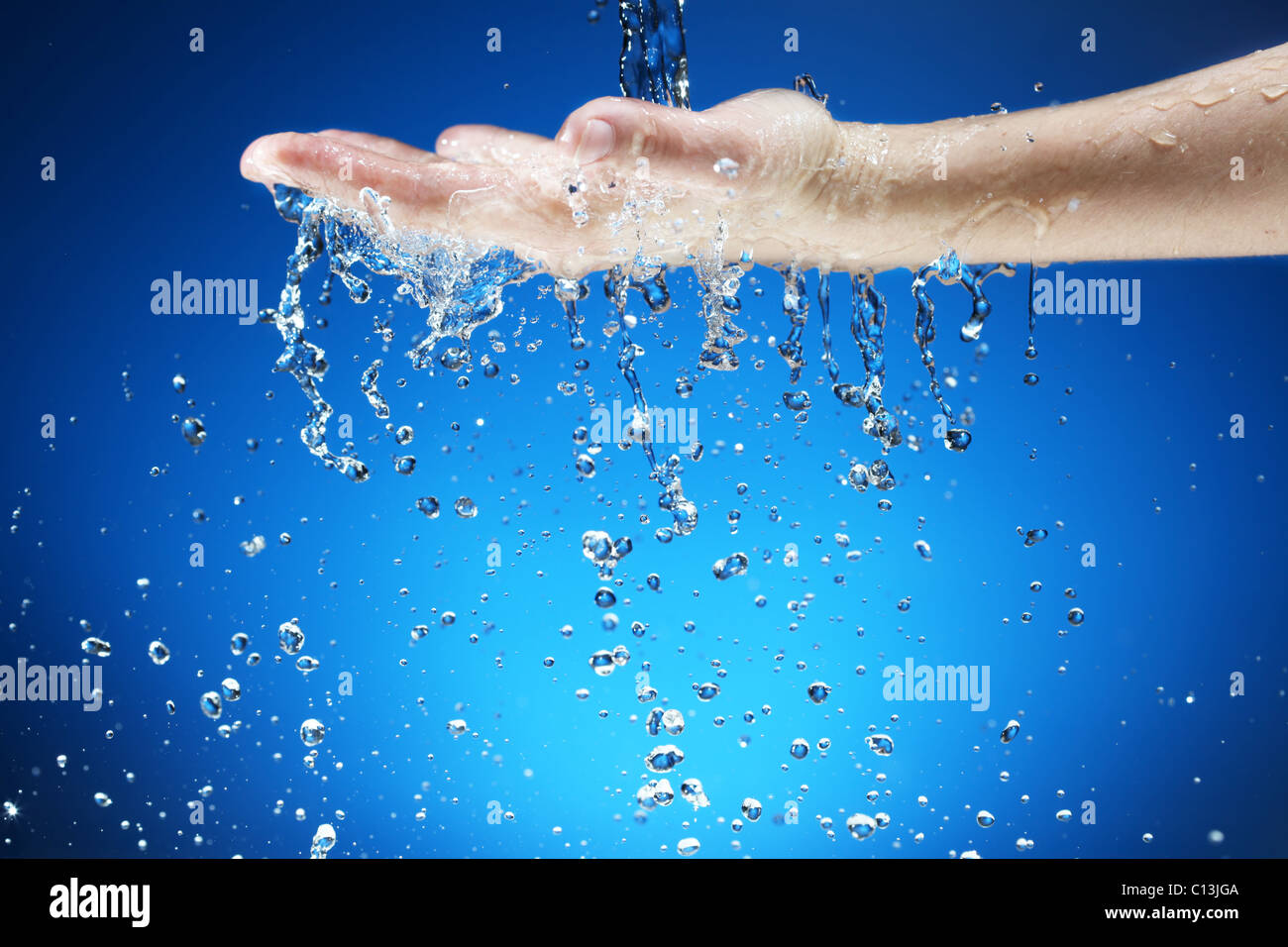 Water falling on hand Stock Photo - Alamy
