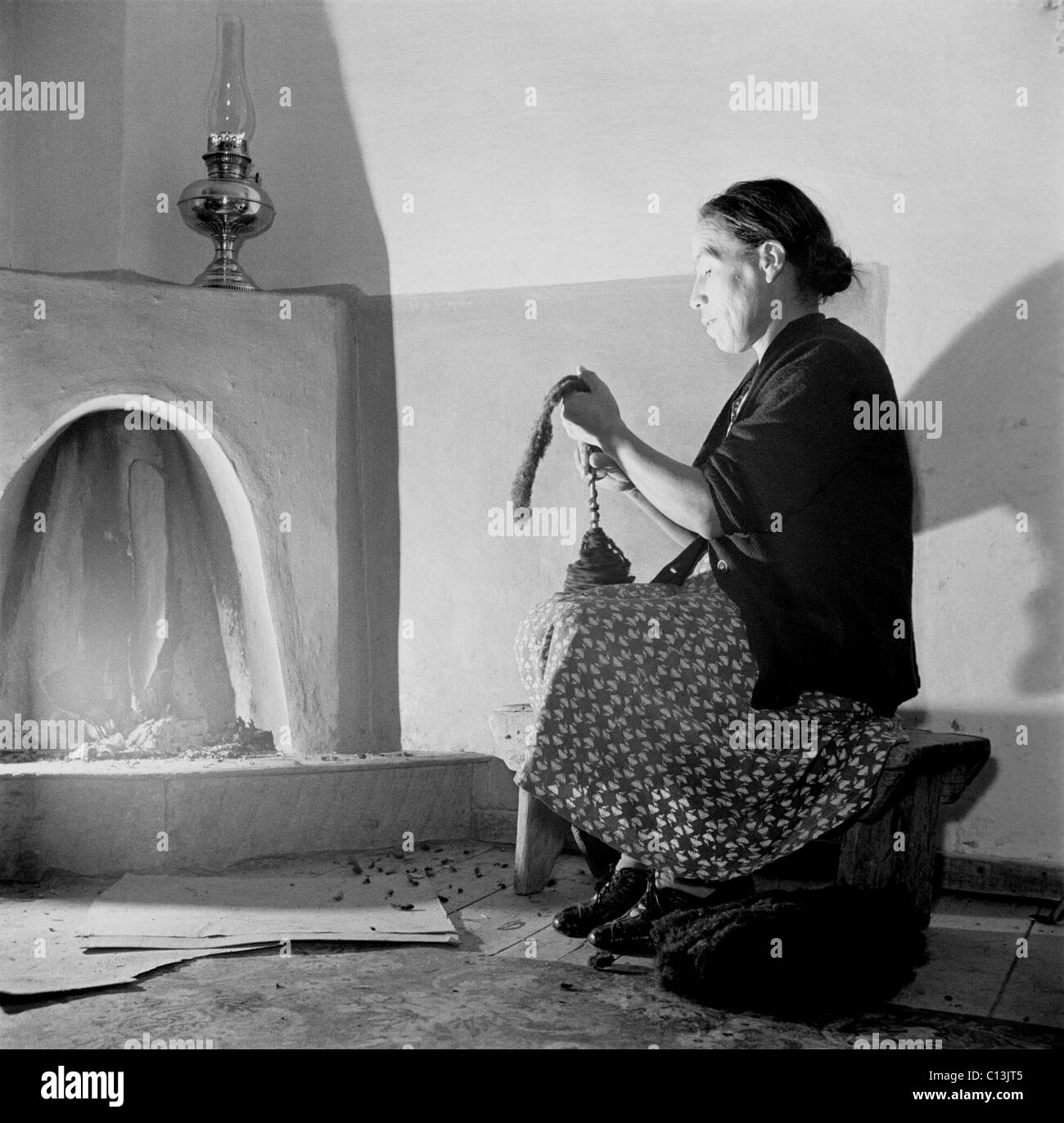 Spanish-American women, Maclovia Lopez, hand spinning wool by the light ...