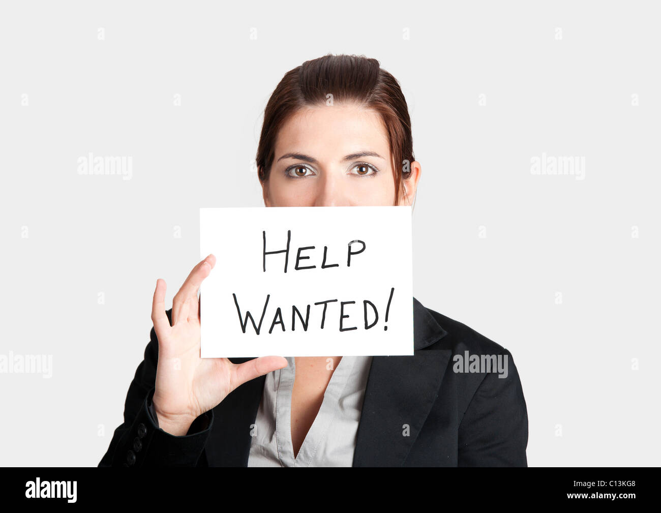 Business woman asking for help holding a cardboard with the text ...