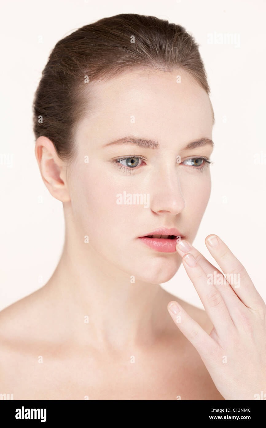 Portrait of young woman touching lips Stock Photo - Alamy