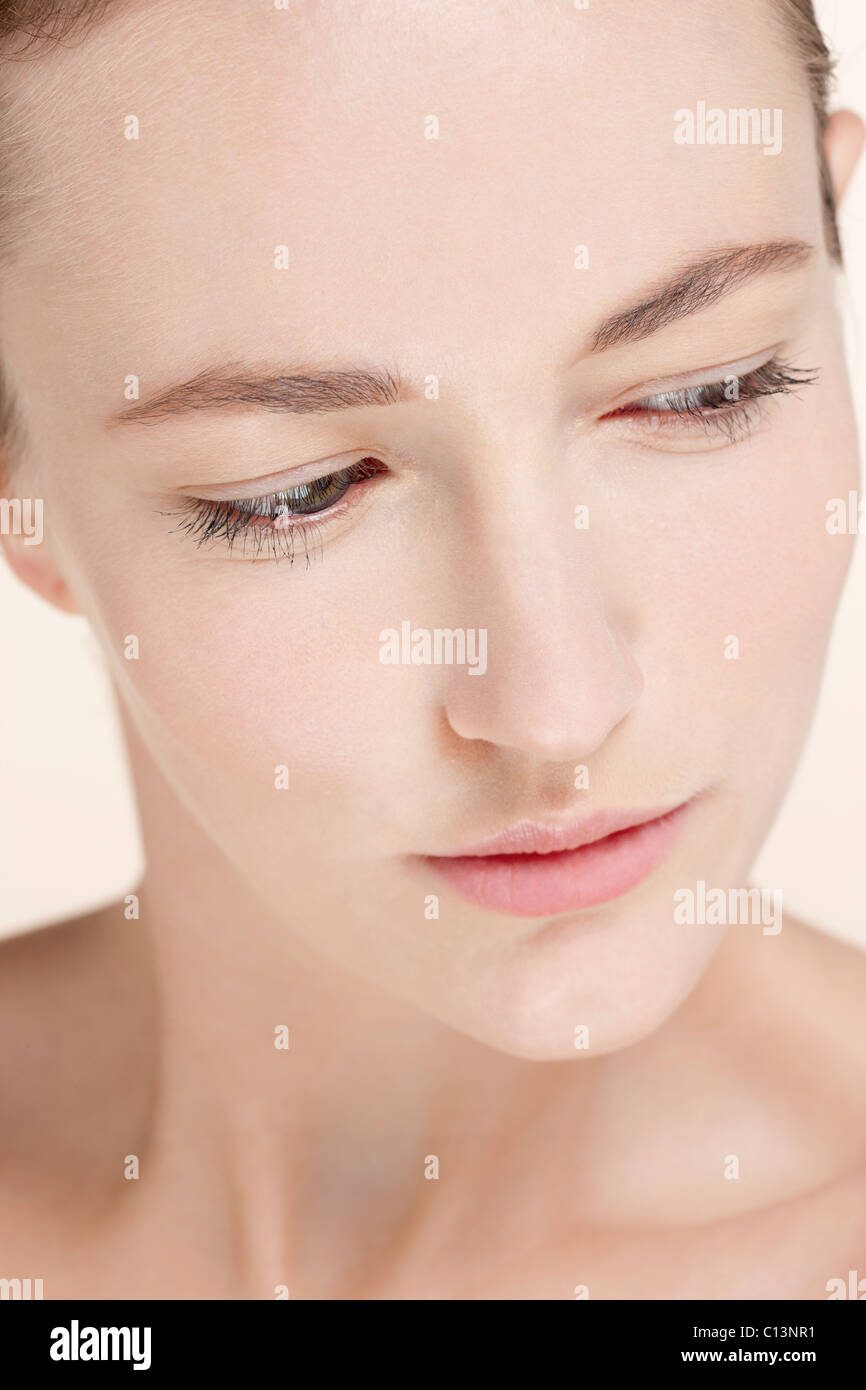 Portrait of young woman looking down Stock Photo - Alamy
