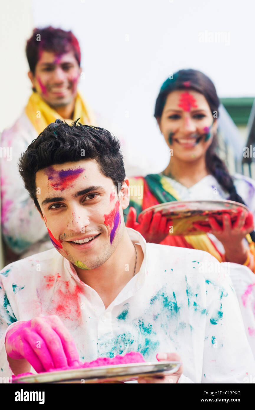 Friends celebrating Holi Stock Photo - Alamy