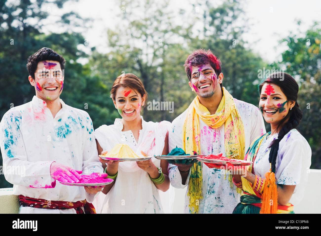 Friends celebrating Holi Stock Photo - Alamy