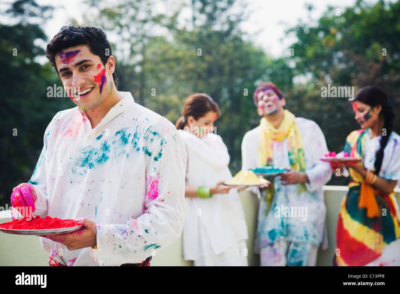 Friends celebrating Holi Stock Photo - Alamy