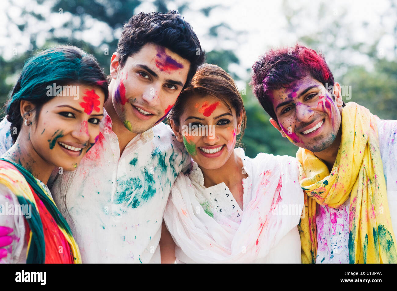 Friends celebrating Holi Stock Photo - Alamy