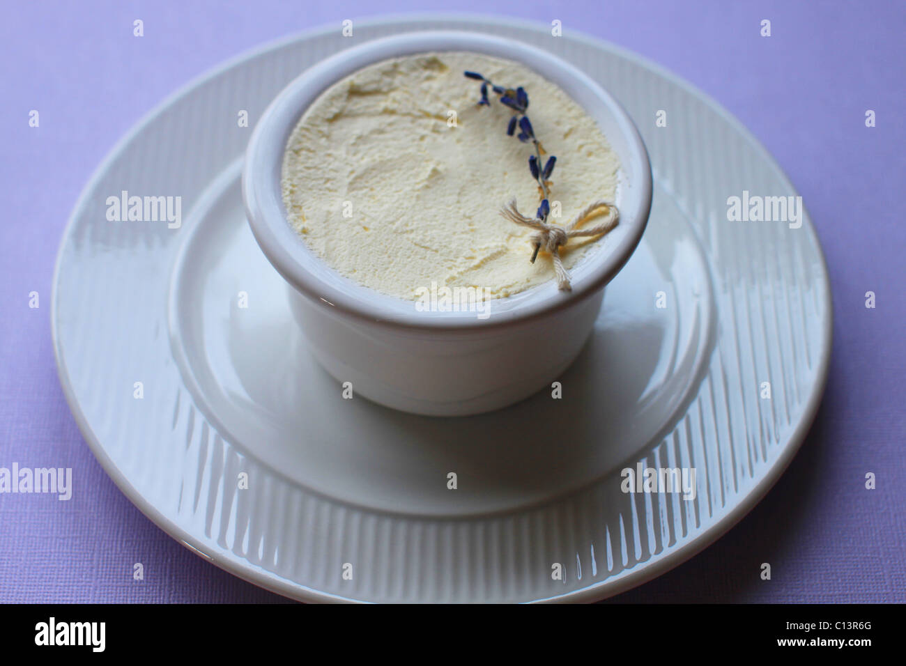 Lavender and Cream Pudding in White Ramekin on White Plate with Lilac ...