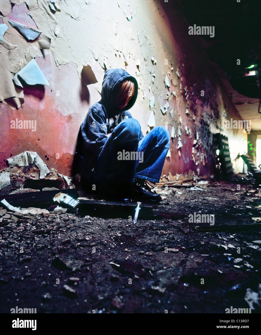 drug user in rough surroundings with syringe and cigarette packet Stock ...